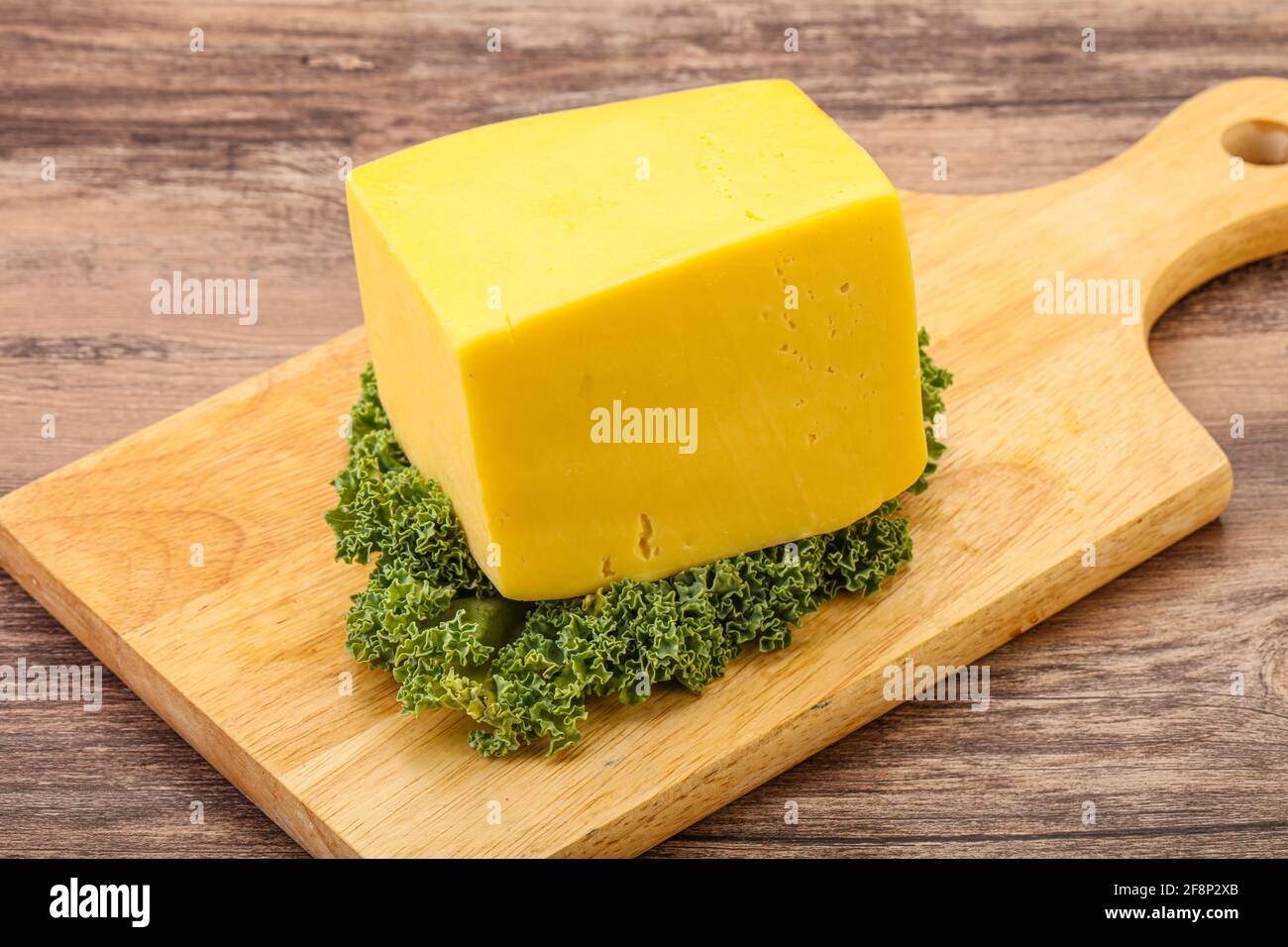Yellow tilsiter cheese dairy product brick Stock Photo - Alamy