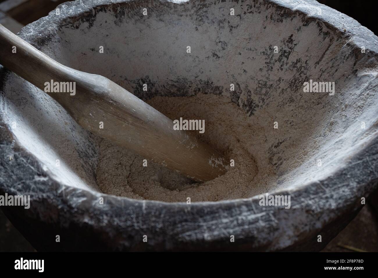 Ancient mortar for grinding flour with a pusher Stock Photo - Alamy