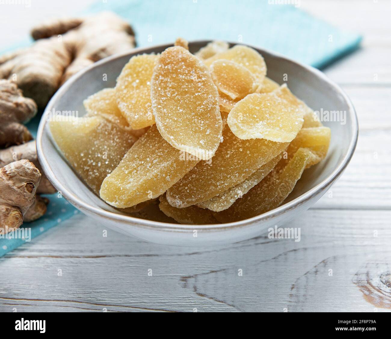 Sweet and spicy candied ginger on a old white wooden table Stock Photo ...