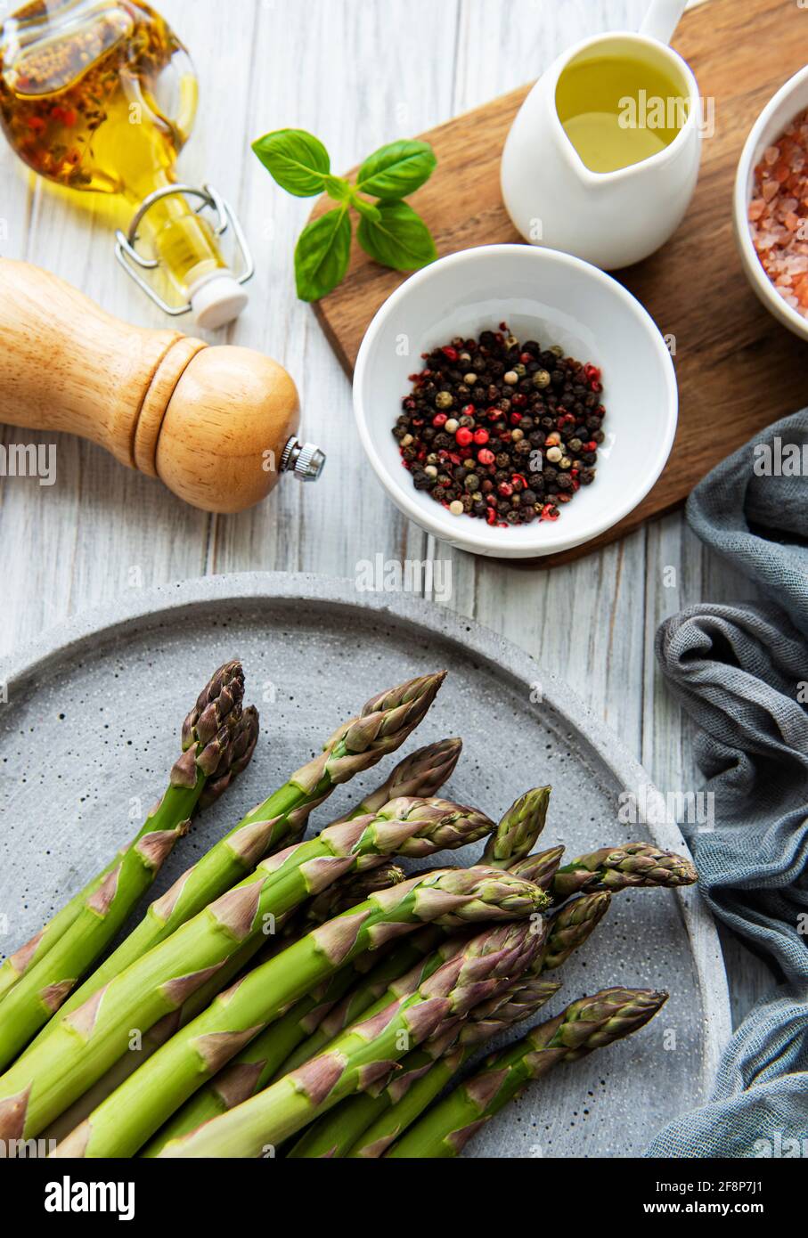 Bunch of raw asparagus stems with different spices and ingredients on ...