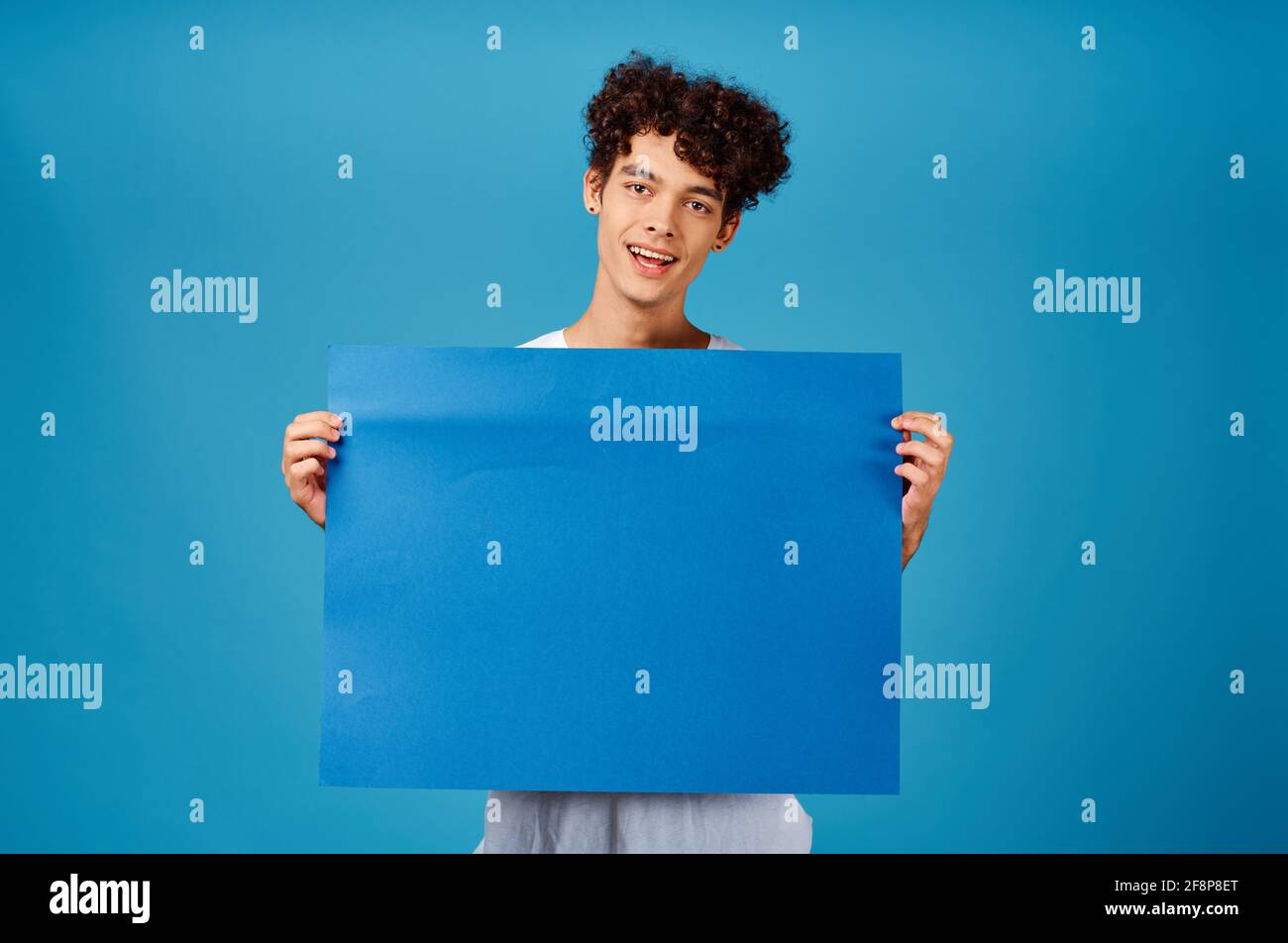 guy in white t-shirt blue poster advertising banner Stock Photo - Alamy
