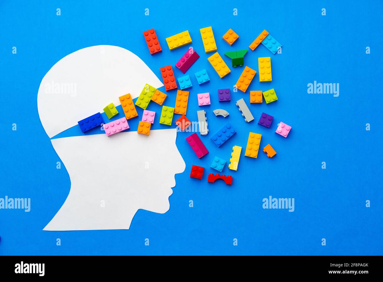 Papercut silhouette of human head with colorful constructor pieces ...
