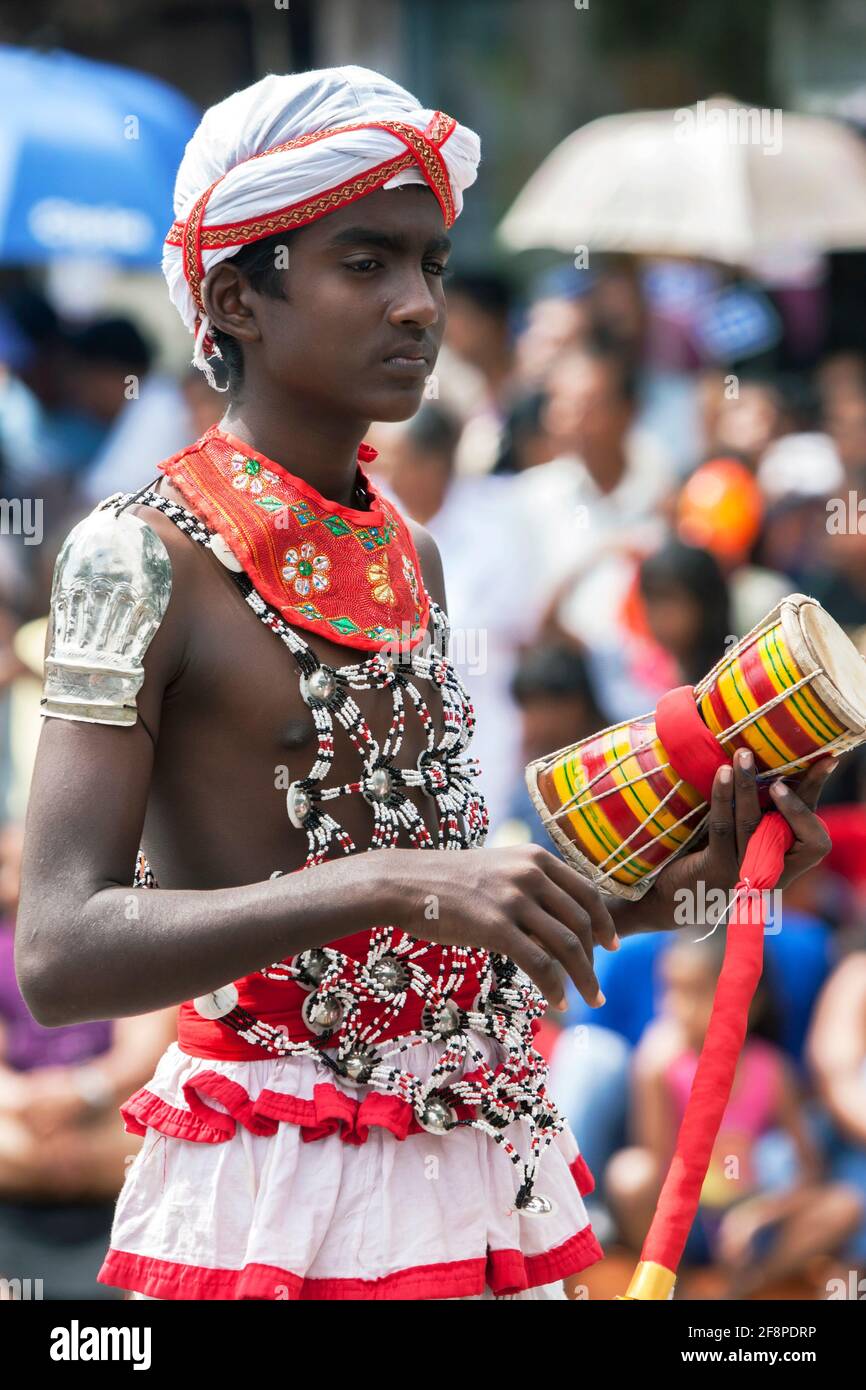 An Udekki Player performs along a street in Kandy during the Day ...