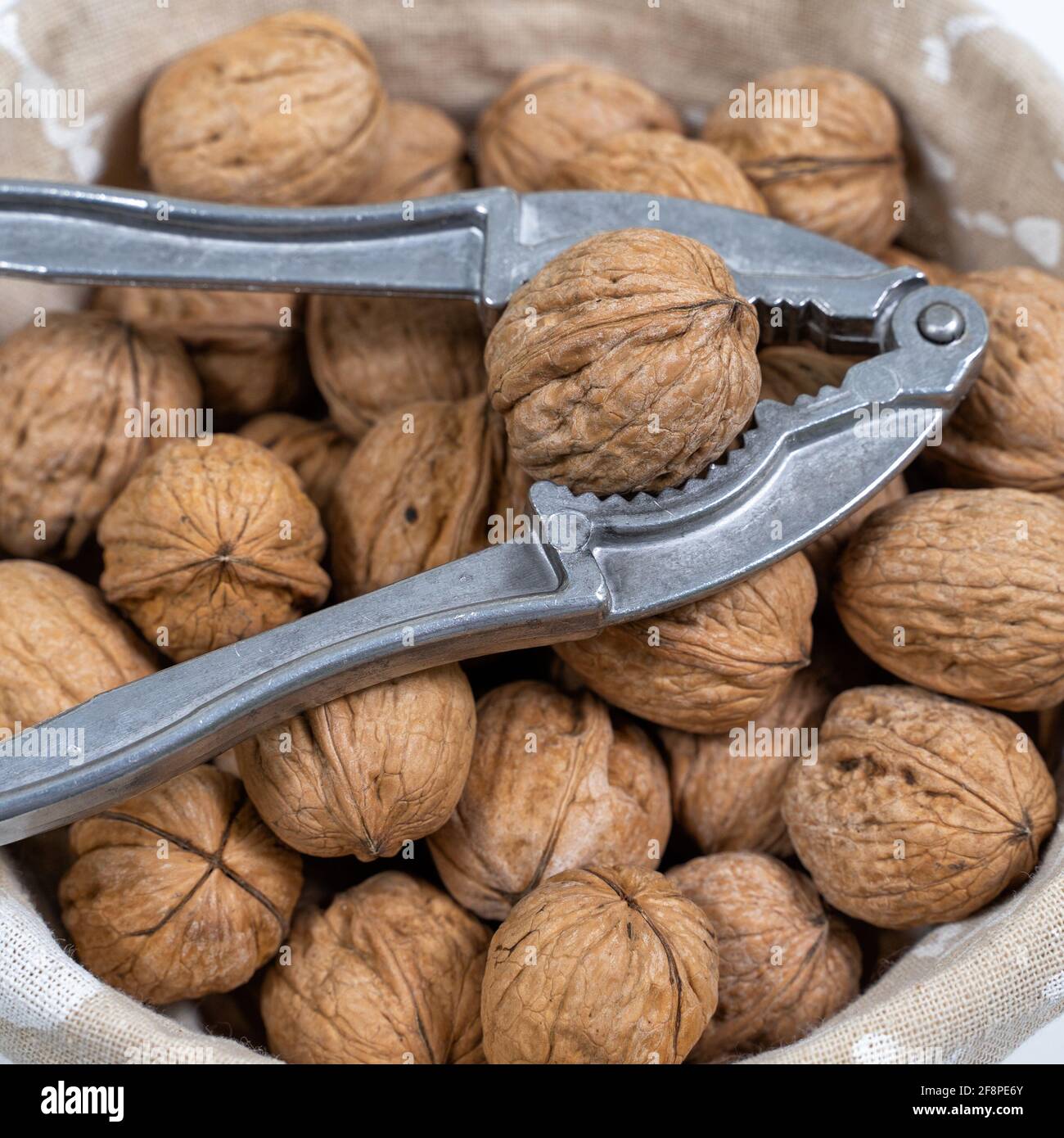 ripe walnuts and iron nutcracker close up Stock Photo - Alamy