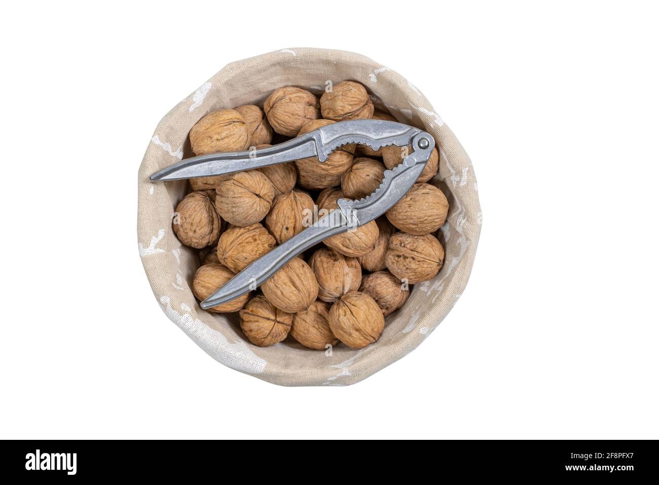 ripe walnuts and an iron nutcracker. isolate on white background, top ...