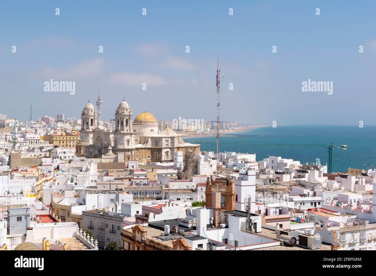 Cityscape of Cadiz surrounded by the sea under the sunlight and a blue ...