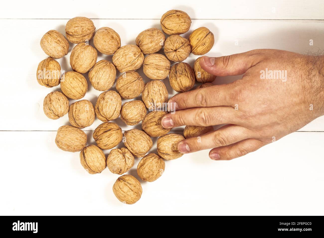male hand forms a heart from walnut. healthy food concept Stock Photo ...