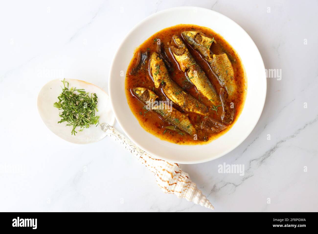 Indian fish curry. White Mullet fish curry made with dried mango and ...