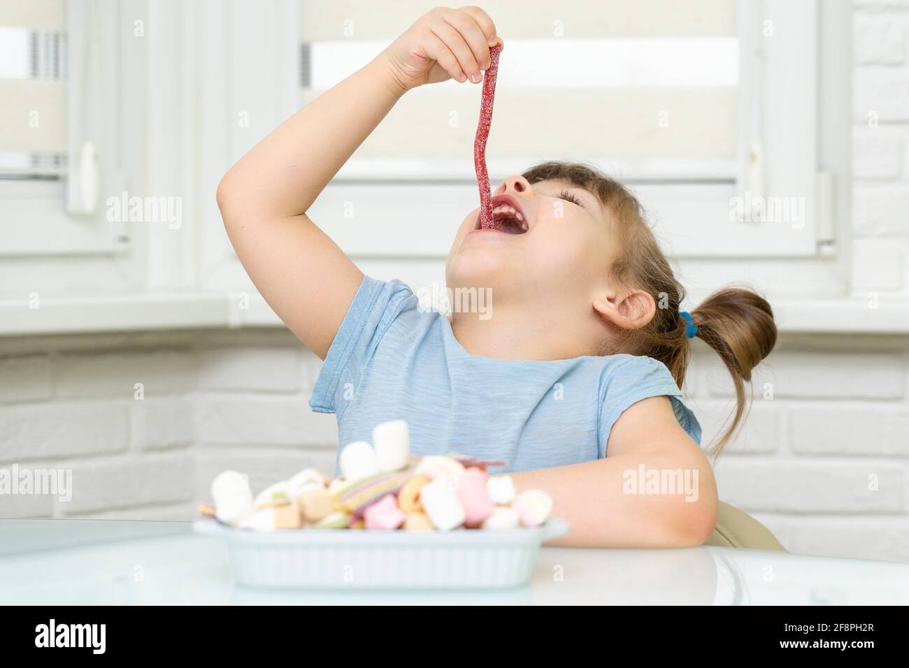 Kid eating sugary sweets hi-res stock photography and images - Alamy