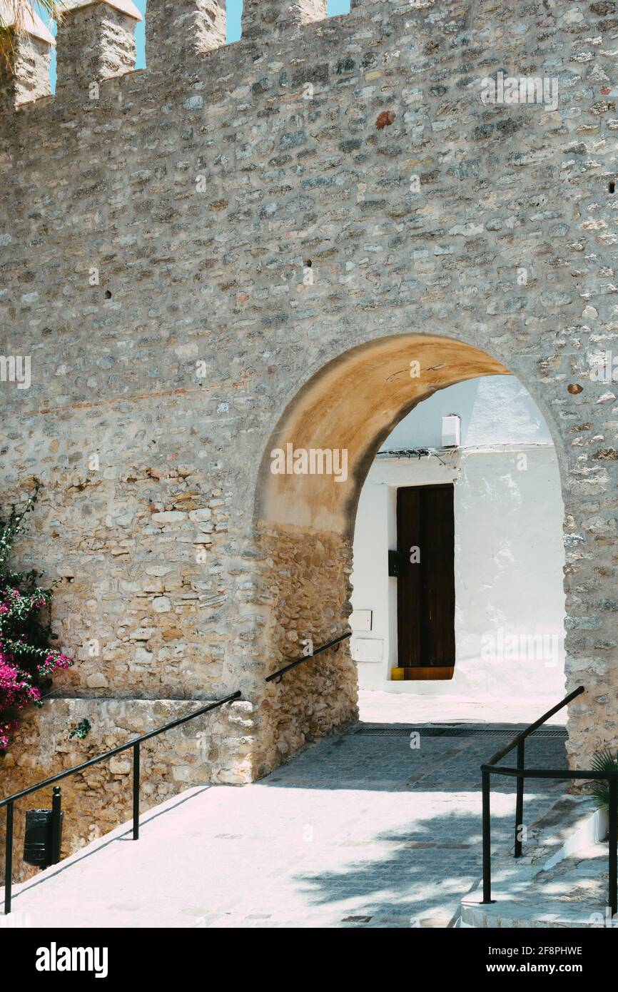 Stone arch with a small footbridge in Vejer de la Frontera, Spain Stock ...