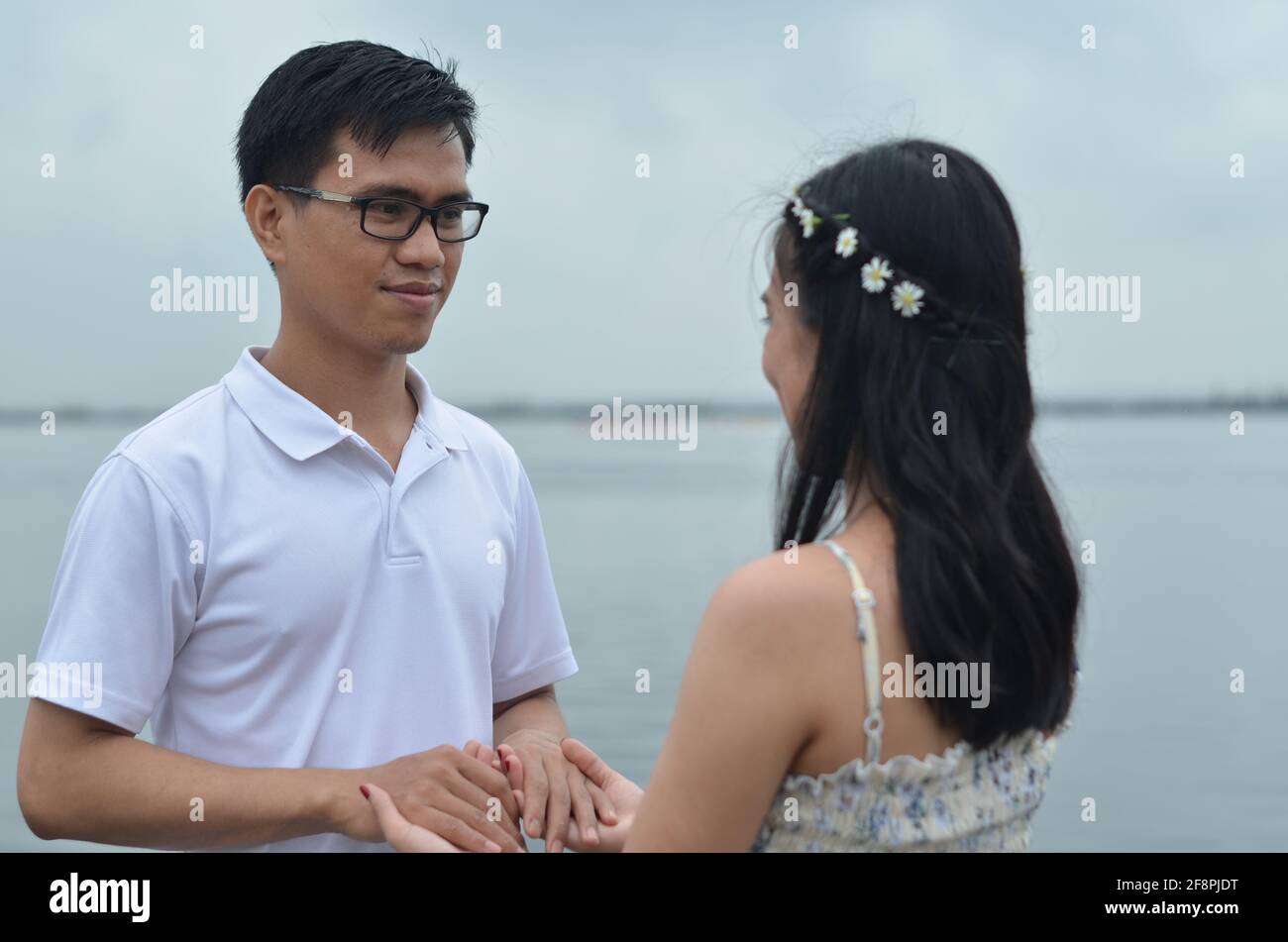 A couple facing each other and holding hands Stock Photo - Alamy