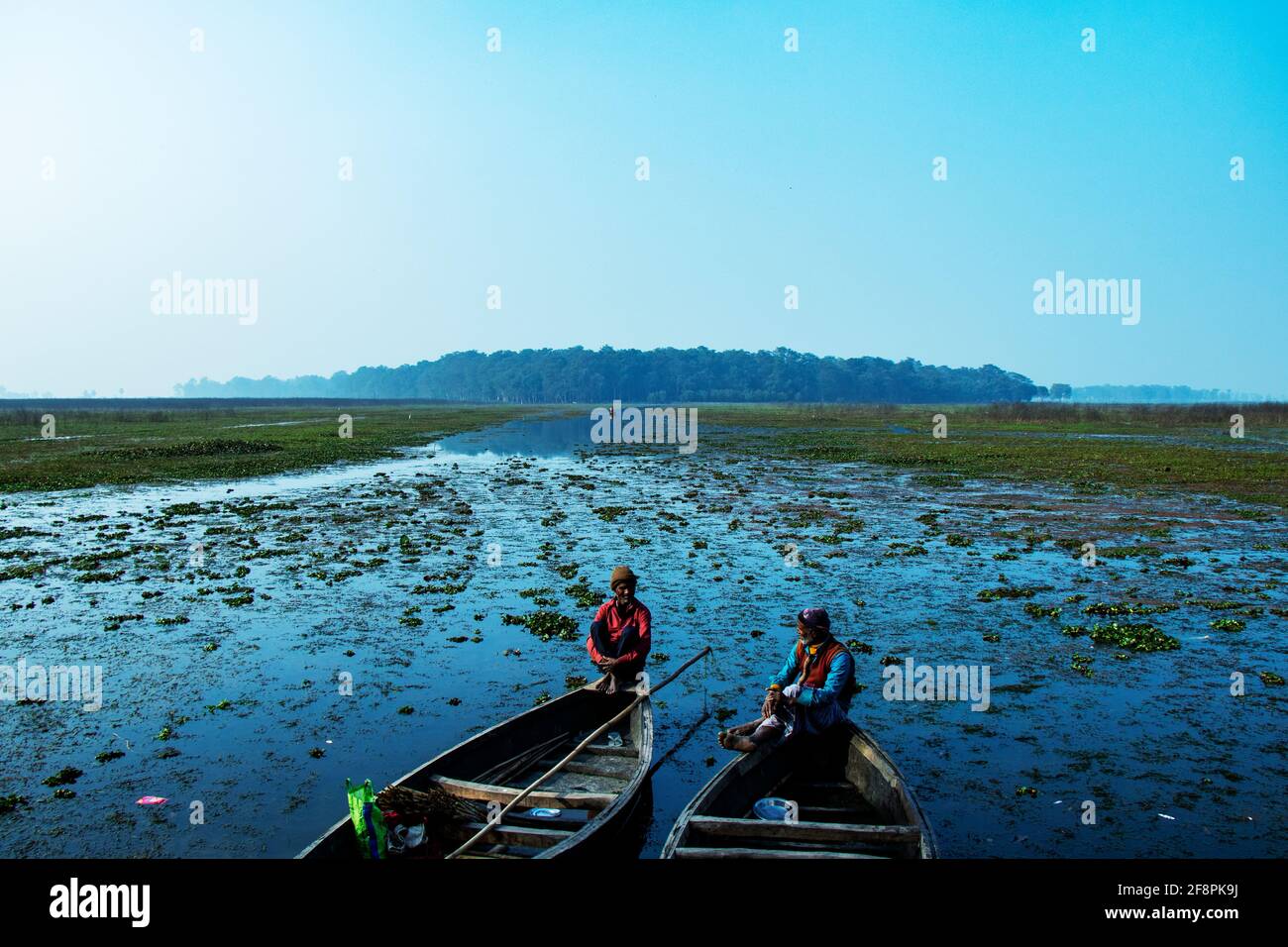 Two fisherman talking and looking for fishes on boats Stock Photo - Alamy