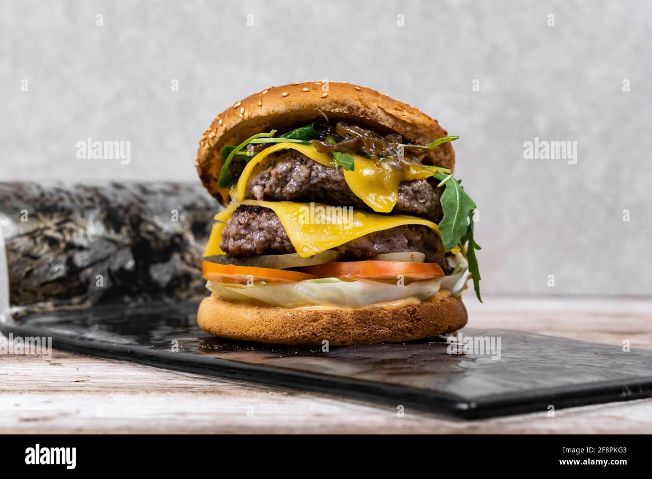 Double Beef Burger on design plate with grey background. Ingredients ...