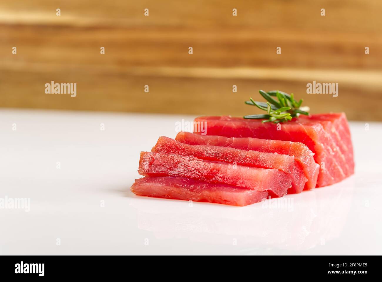tuna sashimi. fresh yellowfin sliced tuna steak a white table. bluefin ...