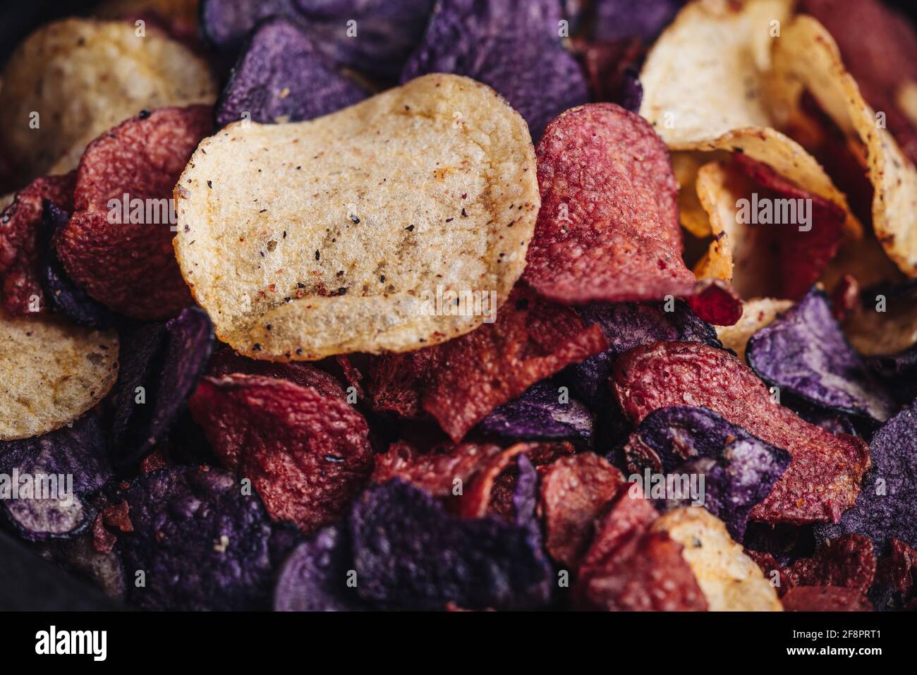 Crispy potato chips in various colors Stock Photo - Alamy