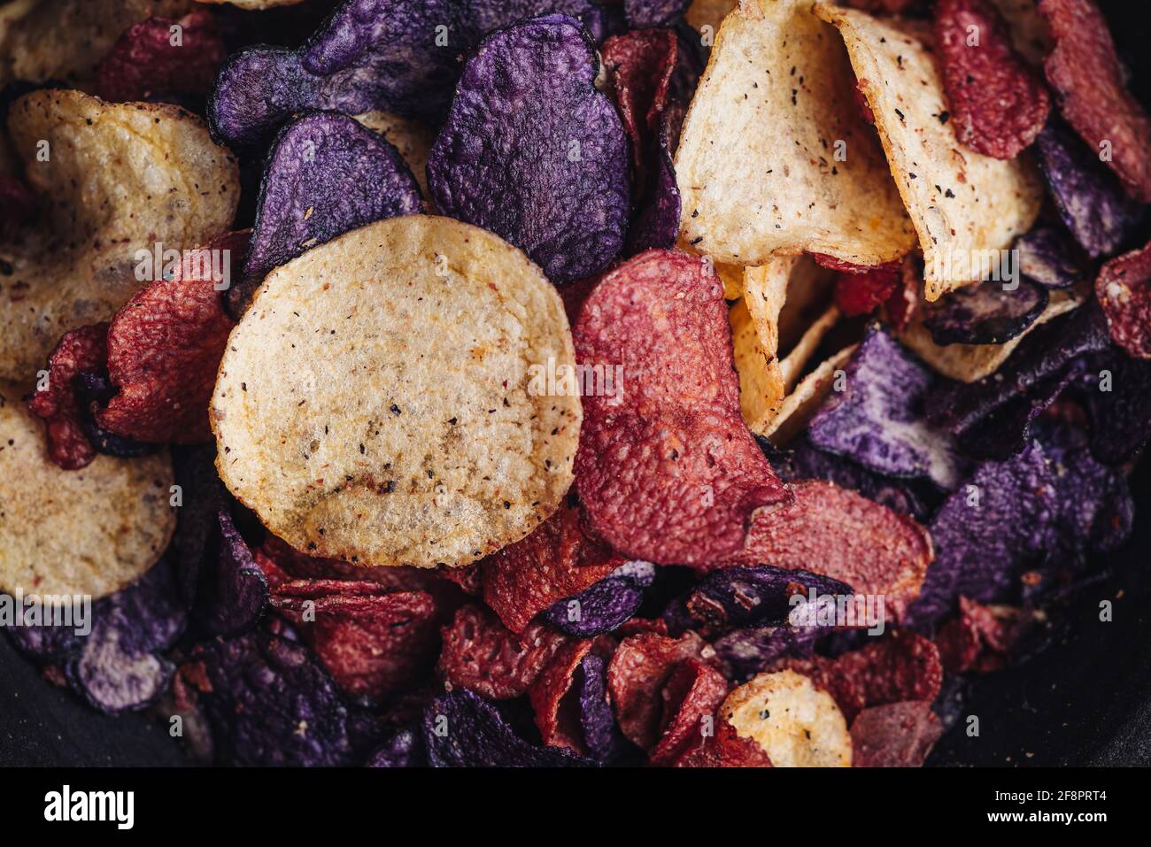 Crispy potato chips in various colors Stock Photo - Alamy