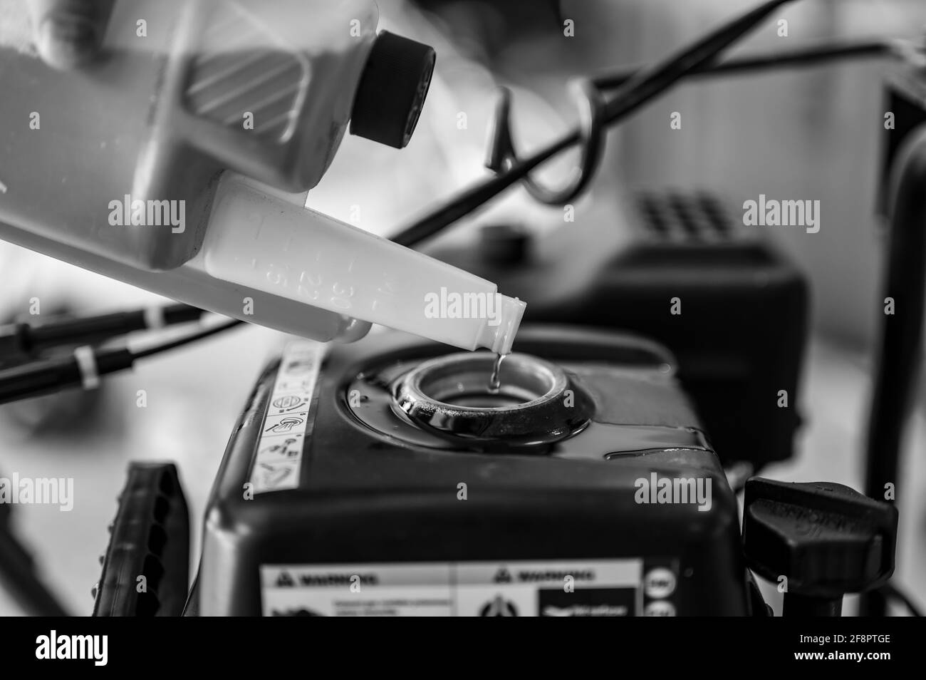 Open gas tank with stabilizer fuel additive being put in before storage ...