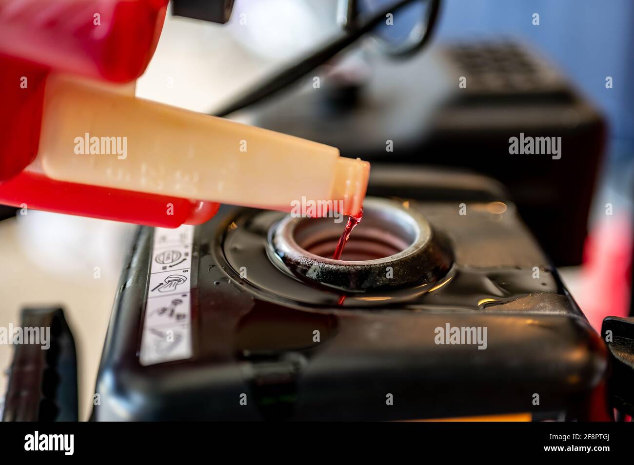 Open gas tank with stabilizer fuel additive being put in before storage ...