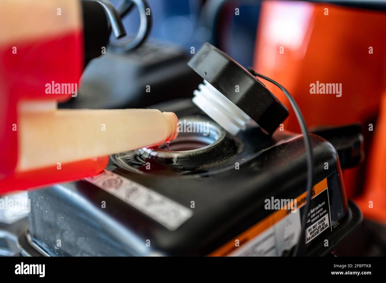 Open gas tank with stabilizer fuel additive being put in before storage ...