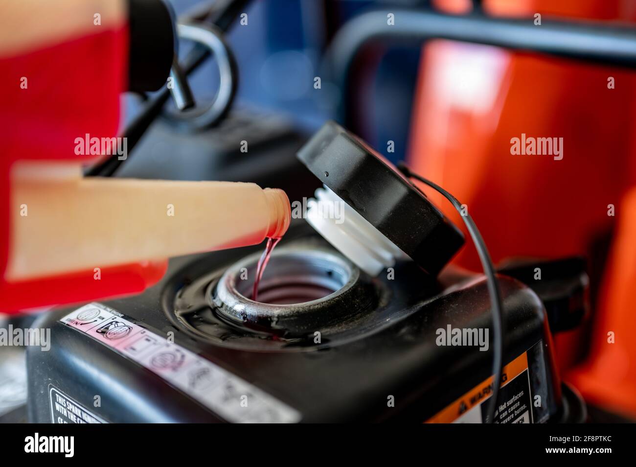 Open gas tank with stabilizer fuel additive being put in before storage ...