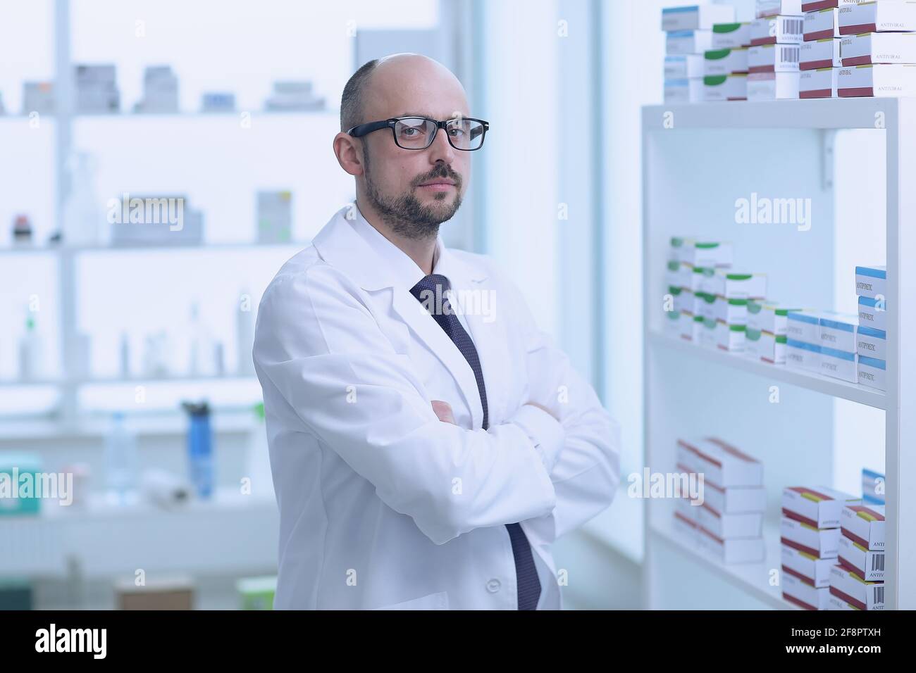 Pharmacist is working. Man wearing special medical uniform located in ...