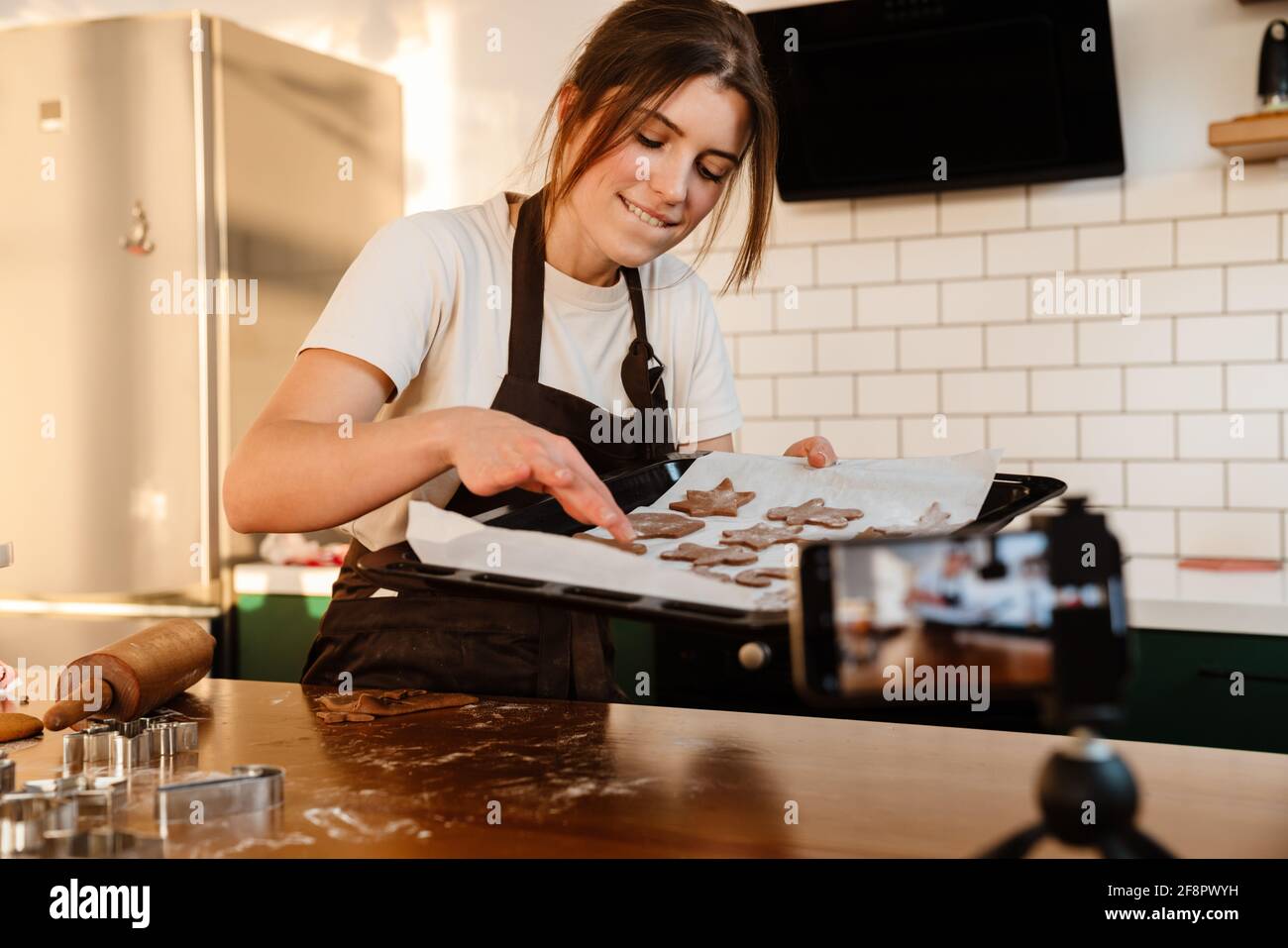 Camera footage of happy baker woman making Christmas cookie at home ...