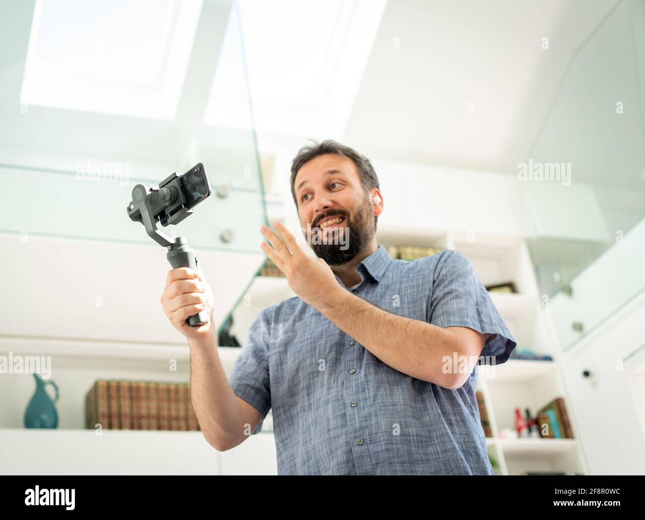 Adult male vlogger streaming online at home Stock Photo - Alamy