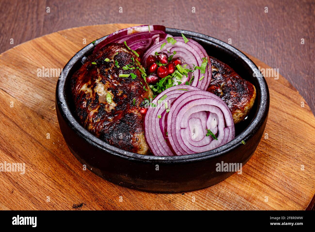 Roasted pork cutlet in the pot served onion Stock Photo - Alamy