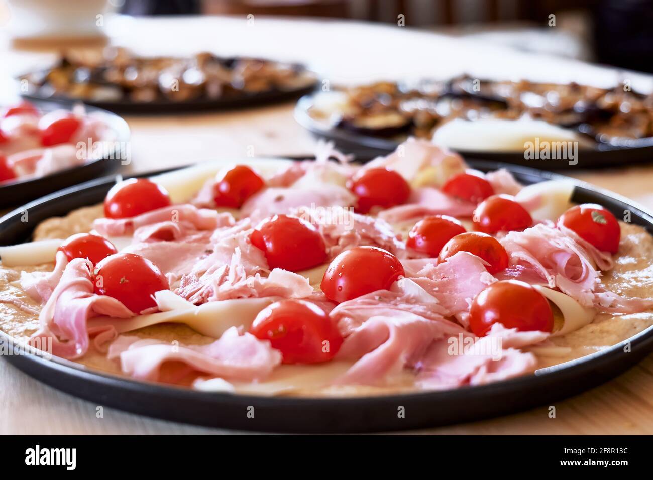 Homemade Italian pizza with tomato, cheese and ham in the plate on the ...