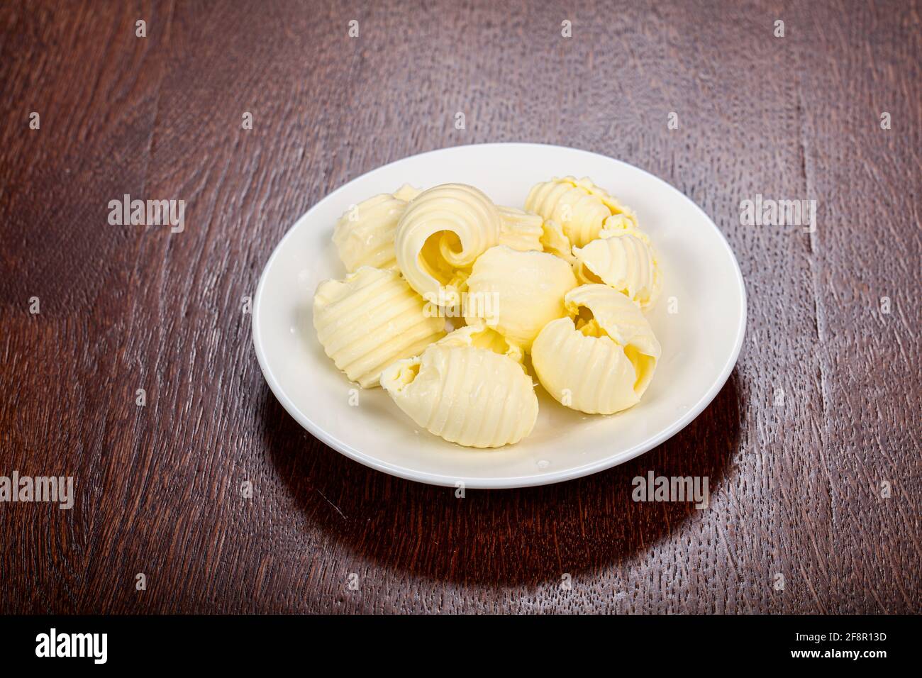 Dairy butter slice for breakfast in the plate Stock Photo - Alamy
