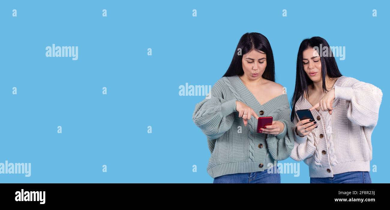 Banner. Amazed, astonished shocked, afraid, scared twin sisters. Girls ...