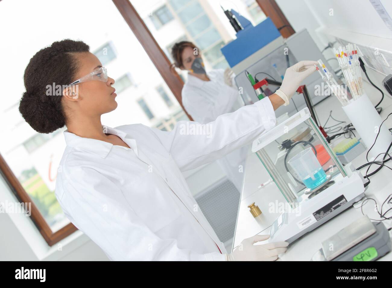 female lab assistant studying blood sample for analysis Stock Photo - Alamy