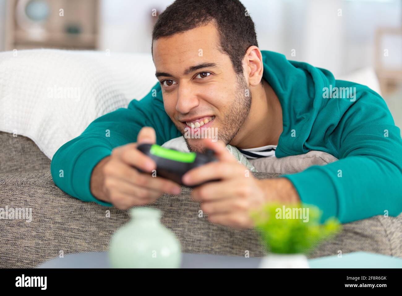 young happy man laughing and playing video games Stock Photo - Alamy