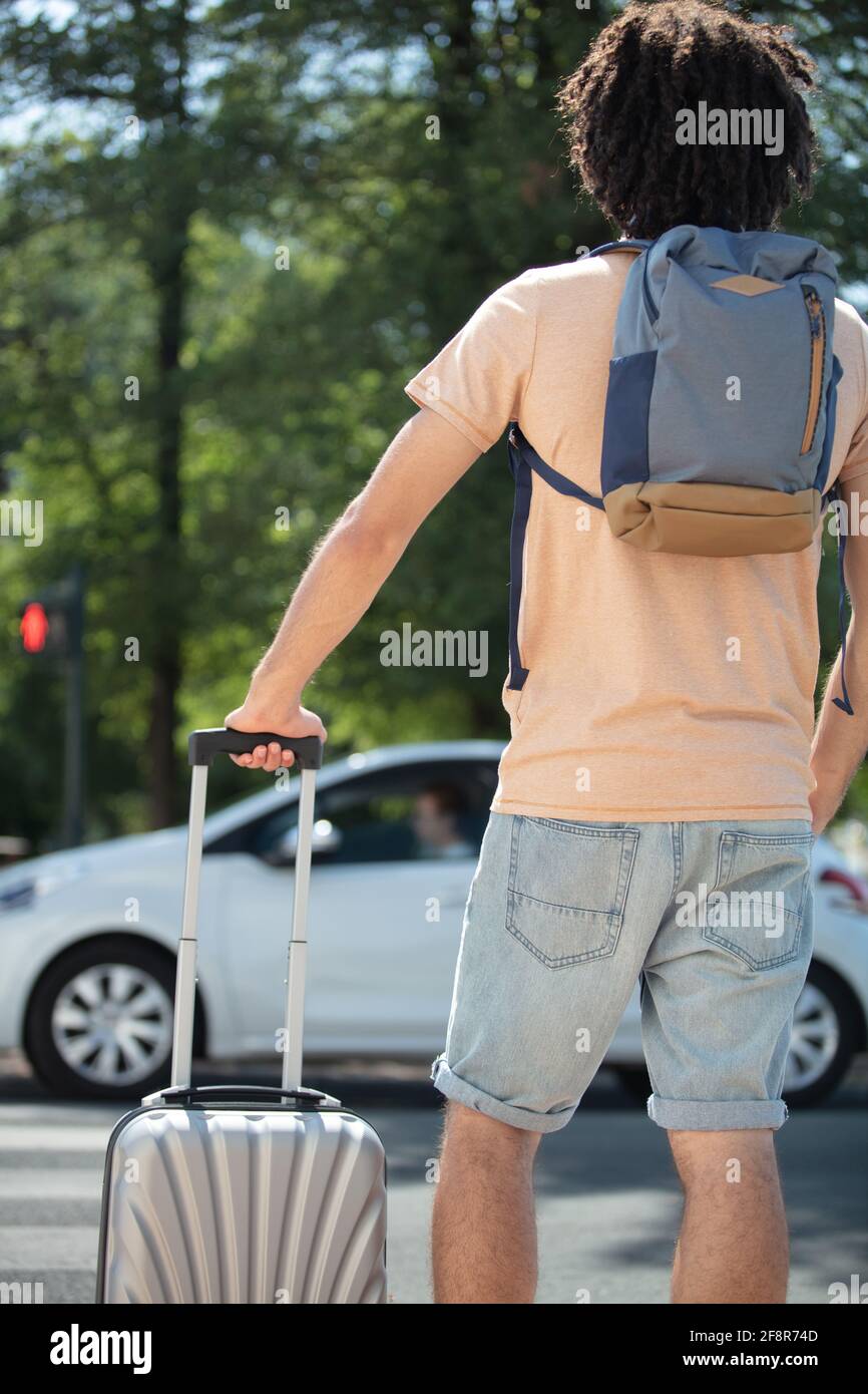 Man pulling suitcase street hi-res stock photography and images - Alamy