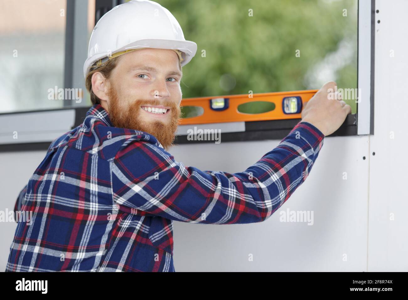 construction worker using spirit level in a new house Stock Photo - Alamy