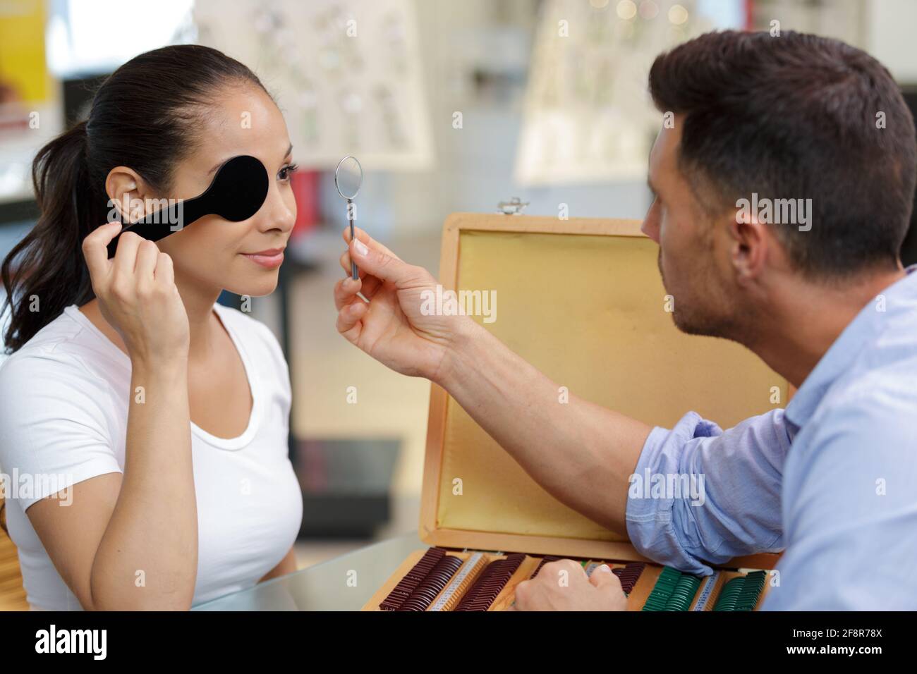 optometrist examining female patient eye with medical equipment Stock ...