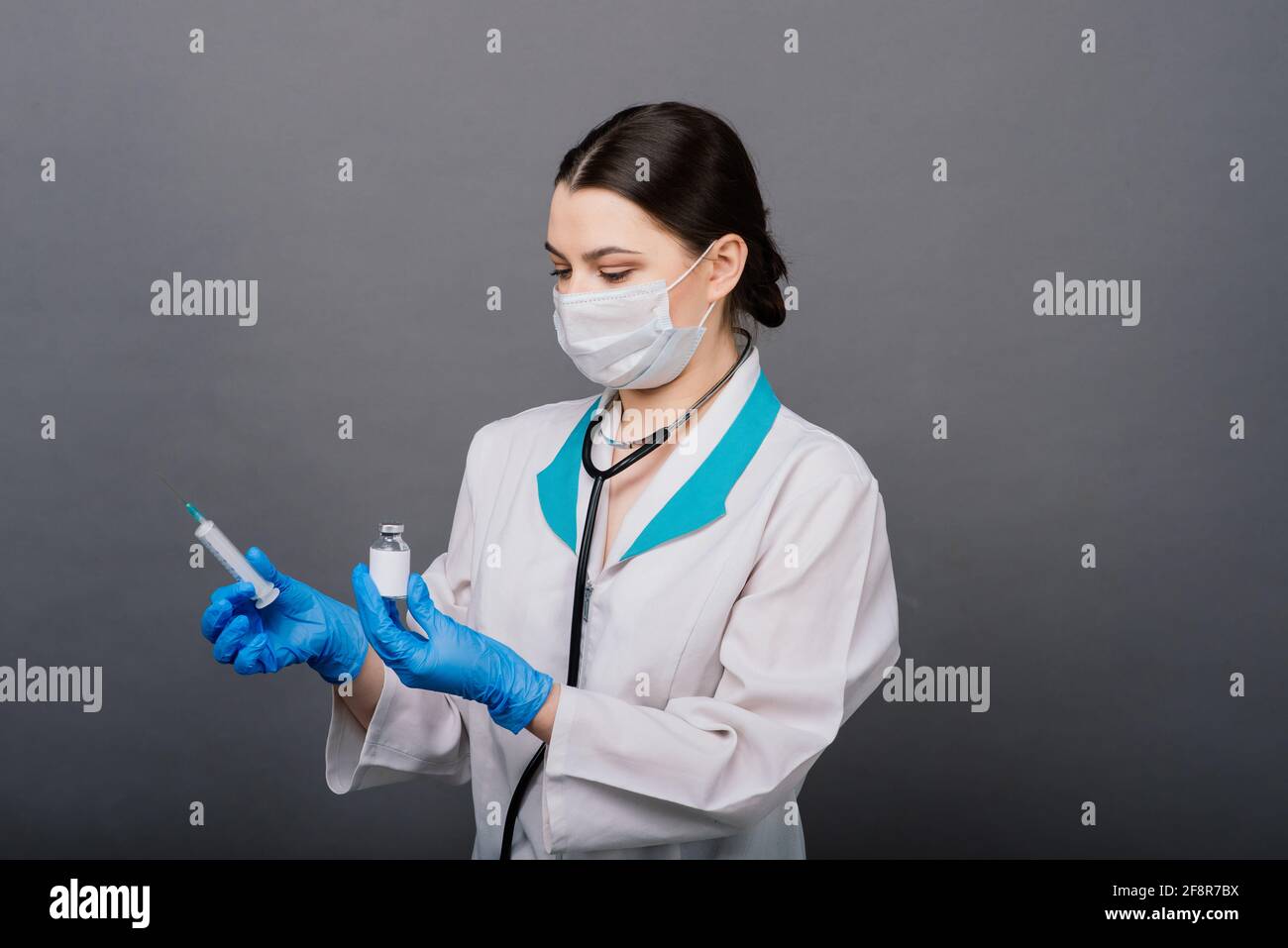 Doctor scientist with syringe analyzing virus in a research vaccine to ...
