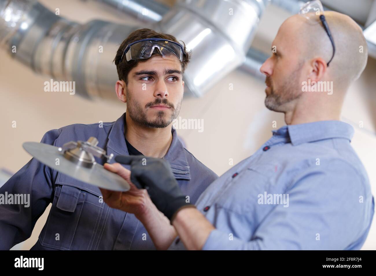 two men during precision work Stock Photo - Alamy
