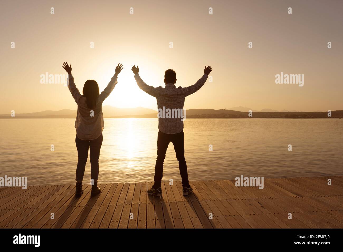 Confidence in the future: view from back silhouette of young couple ...