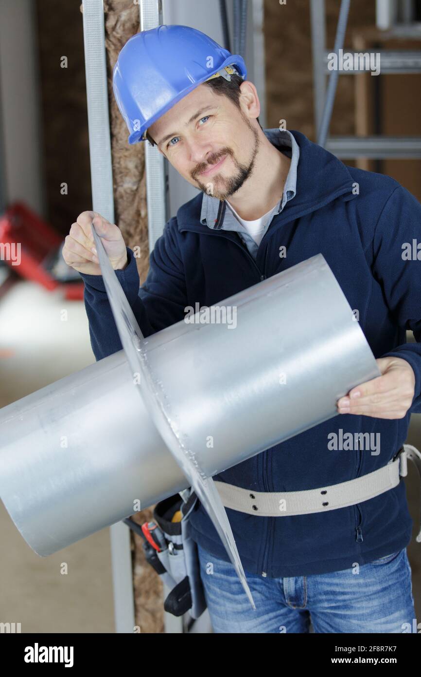 worker holding a plastic pipe Stock Photo - Alamy