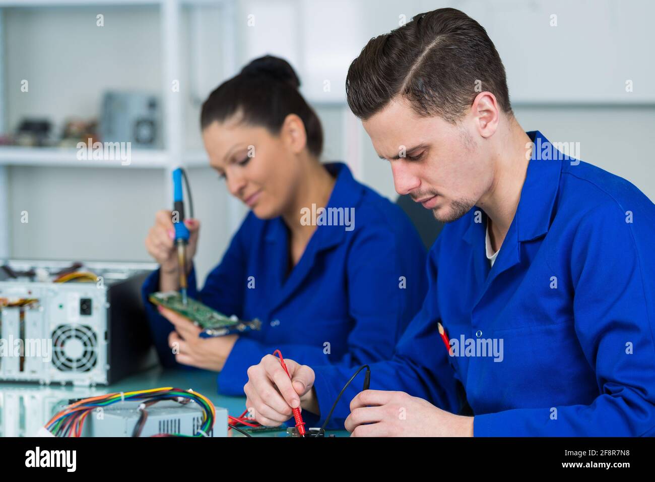 two electricians working as team Stock Photo - Alamy