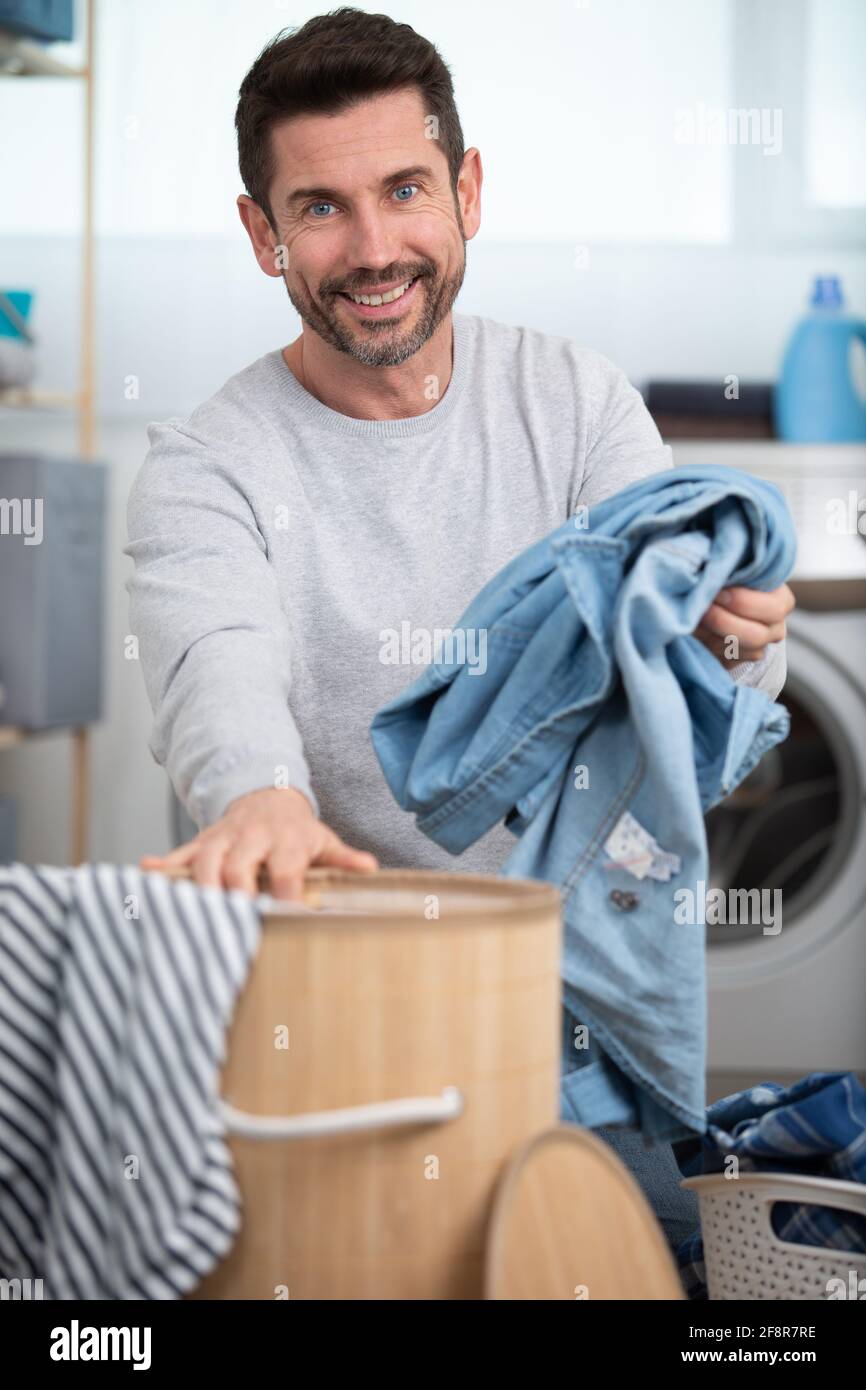 smiling man sorting out the laundry Stock Photo - Alamy