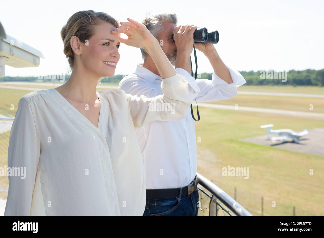a couple is observing something outdoors Stock Photo - Alamy