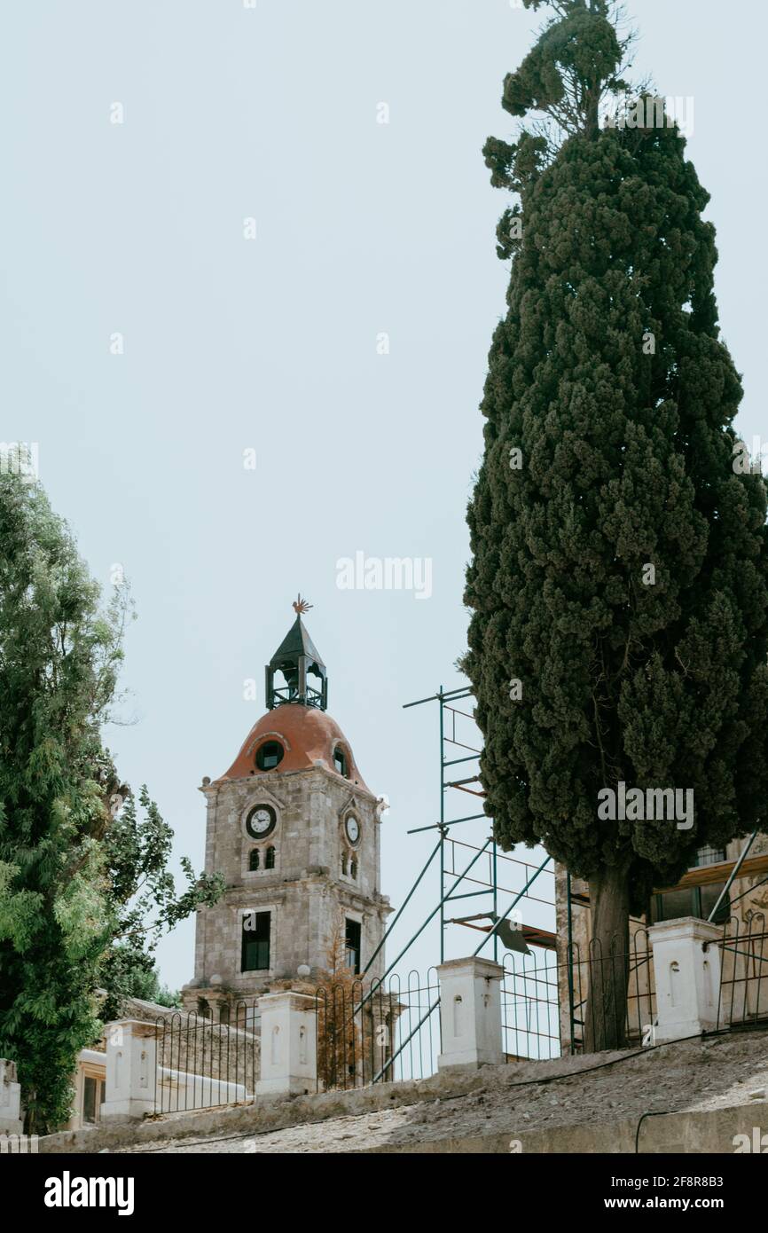 Vertical shot of the medieval clock tower of Roloi in Rhodes, Greece ...
