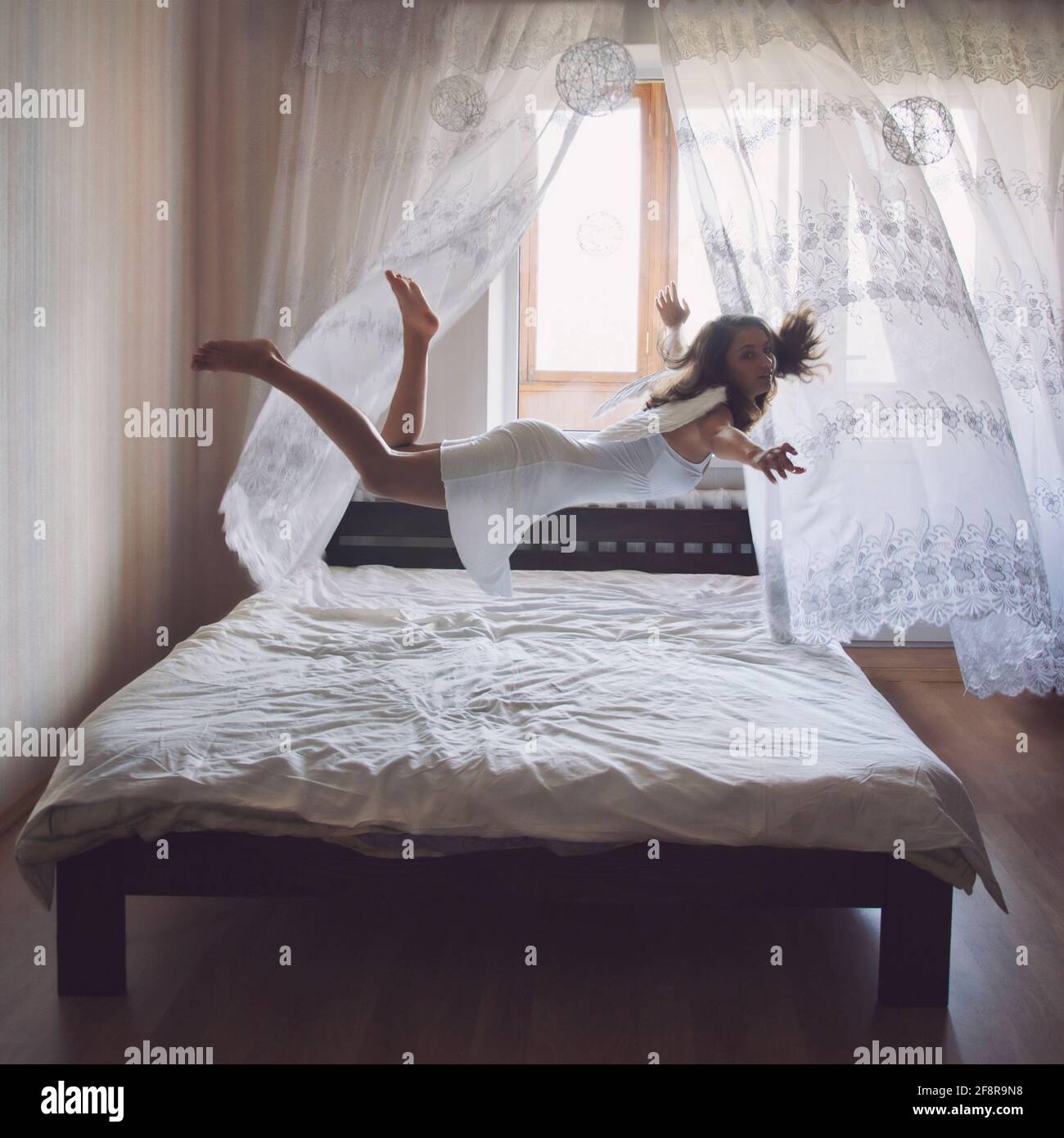 Beautiful girl with angel wings flying Stock Photo - Alamy