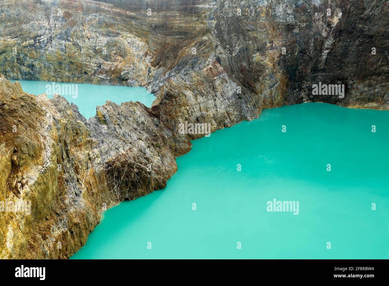 Adjacent green and red volcanic lakes of the famous tri-color - three ...