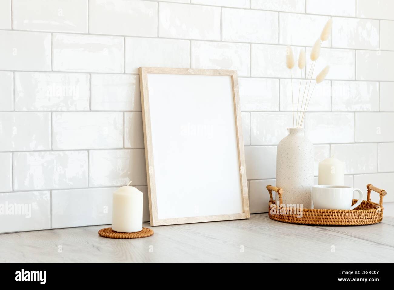 Blank picture frame mockup, rattan tray with cup of coffee, vase of ...