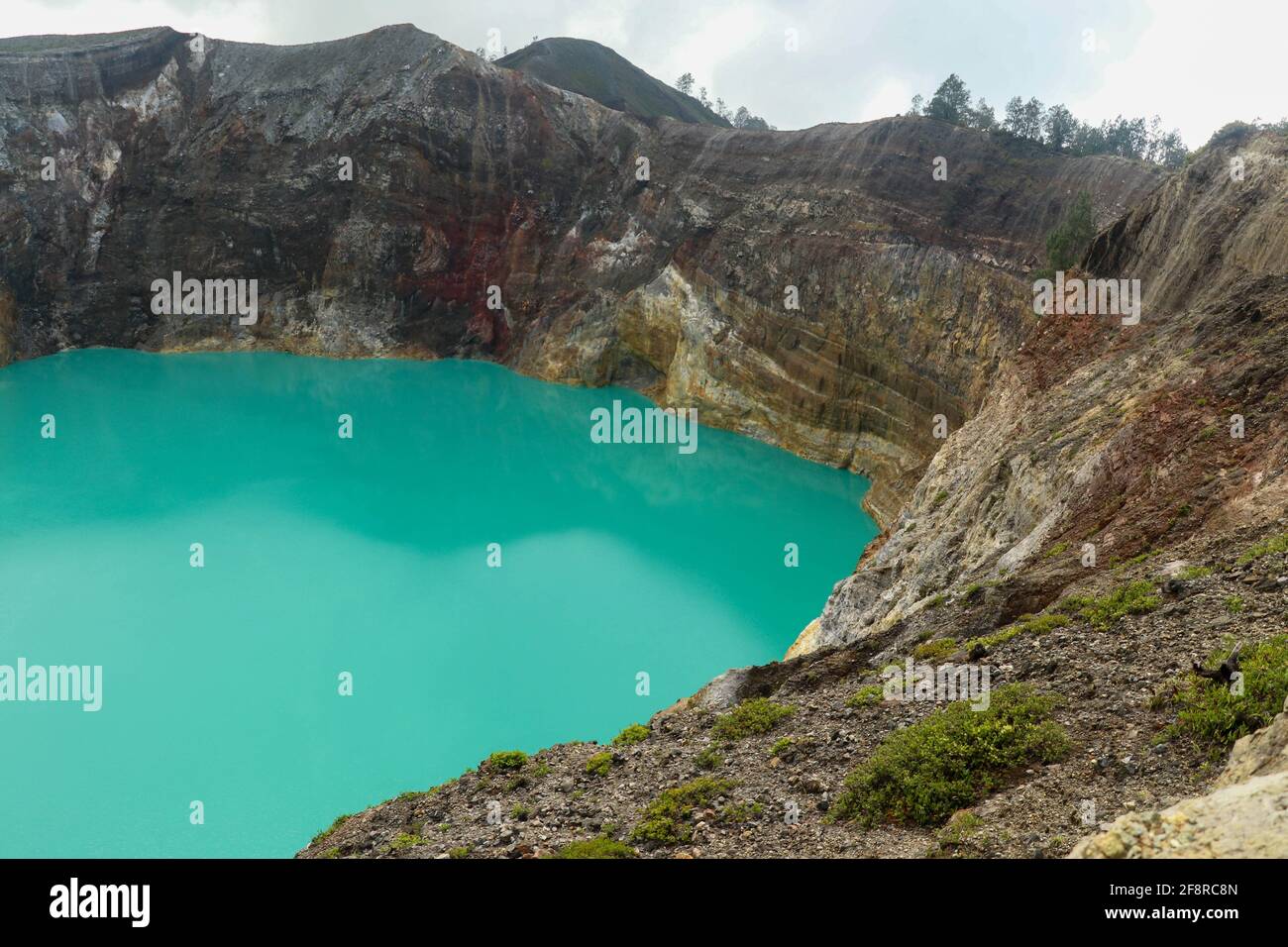 Adjacent green and red volcanic lakes of the famous tri-color - three ...