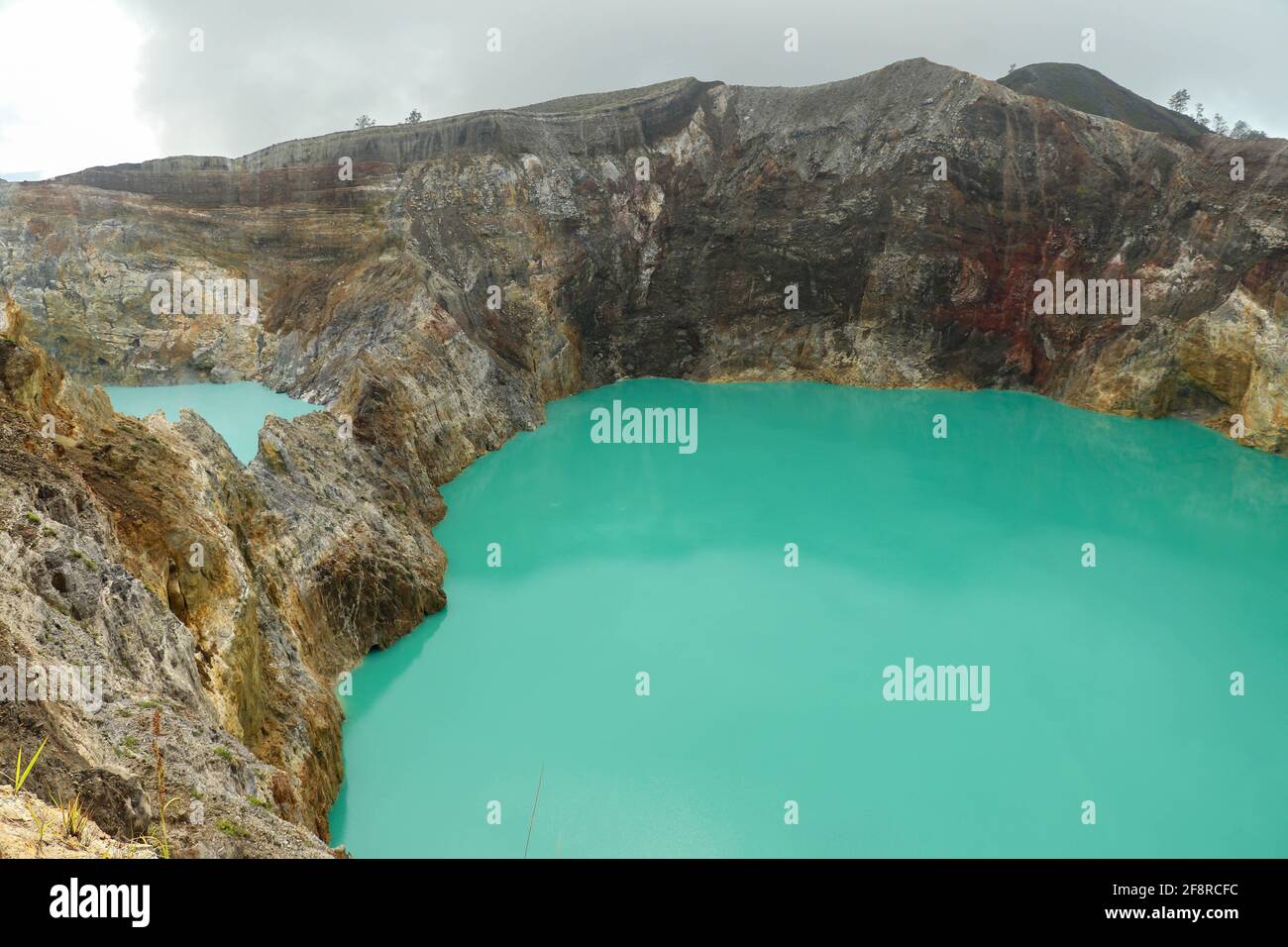 Adjacent green and red volcanic lakes of the famous tri-color - three ...