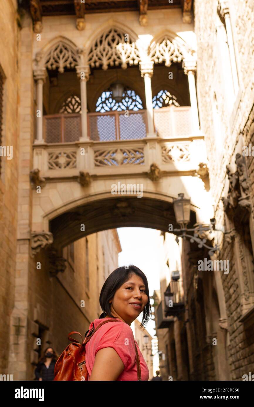 Spanish woman with a backpack strolling through the streets of ...
